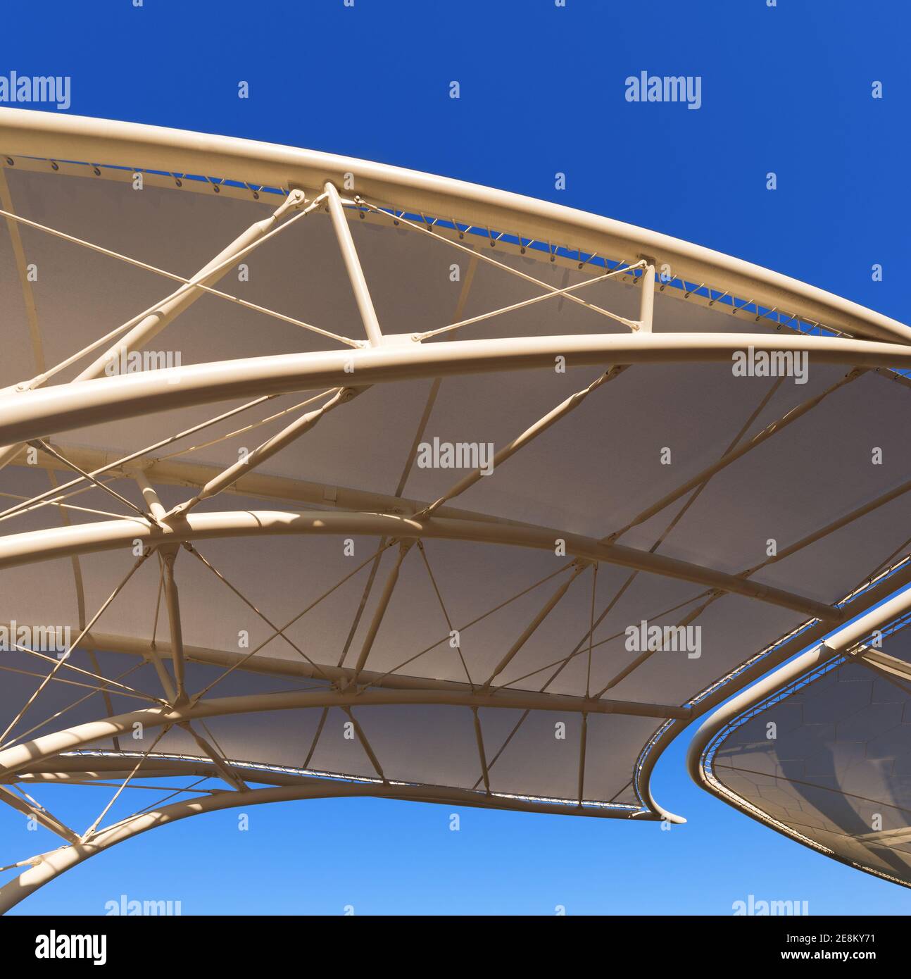Closeup of a modern tensile structure on a clear blue sky, membrane ...