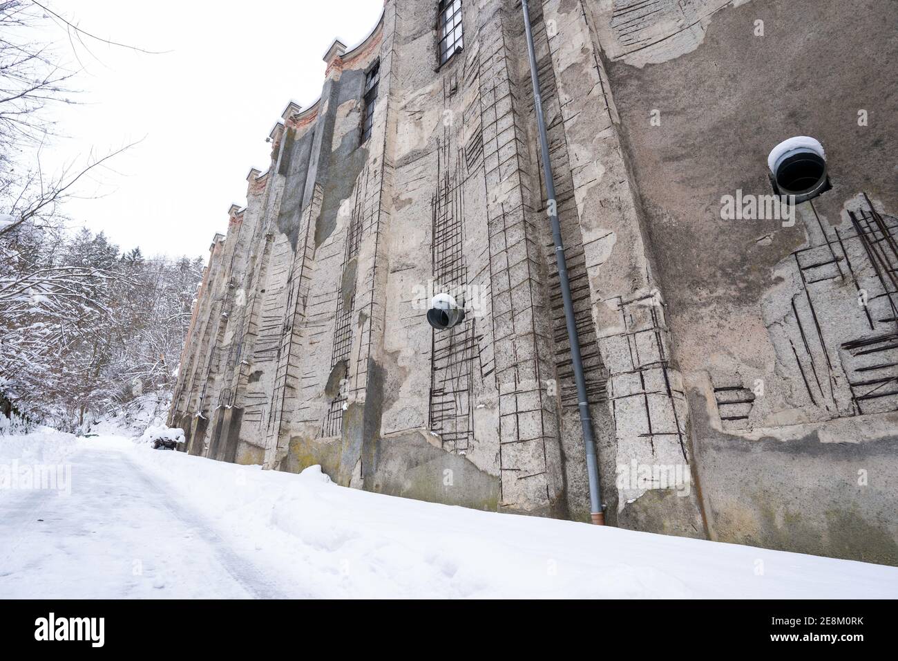 A low angle shot of an old weathered concrete factory building in a ...