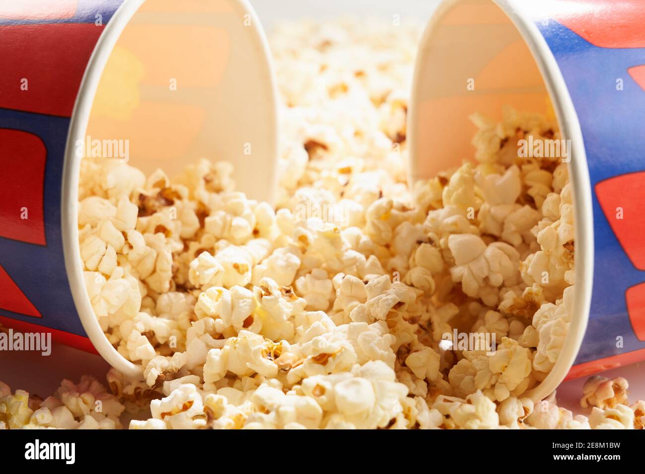 Popcorn scattered from two paper buckets. Concept of cinema Stock Photo ...