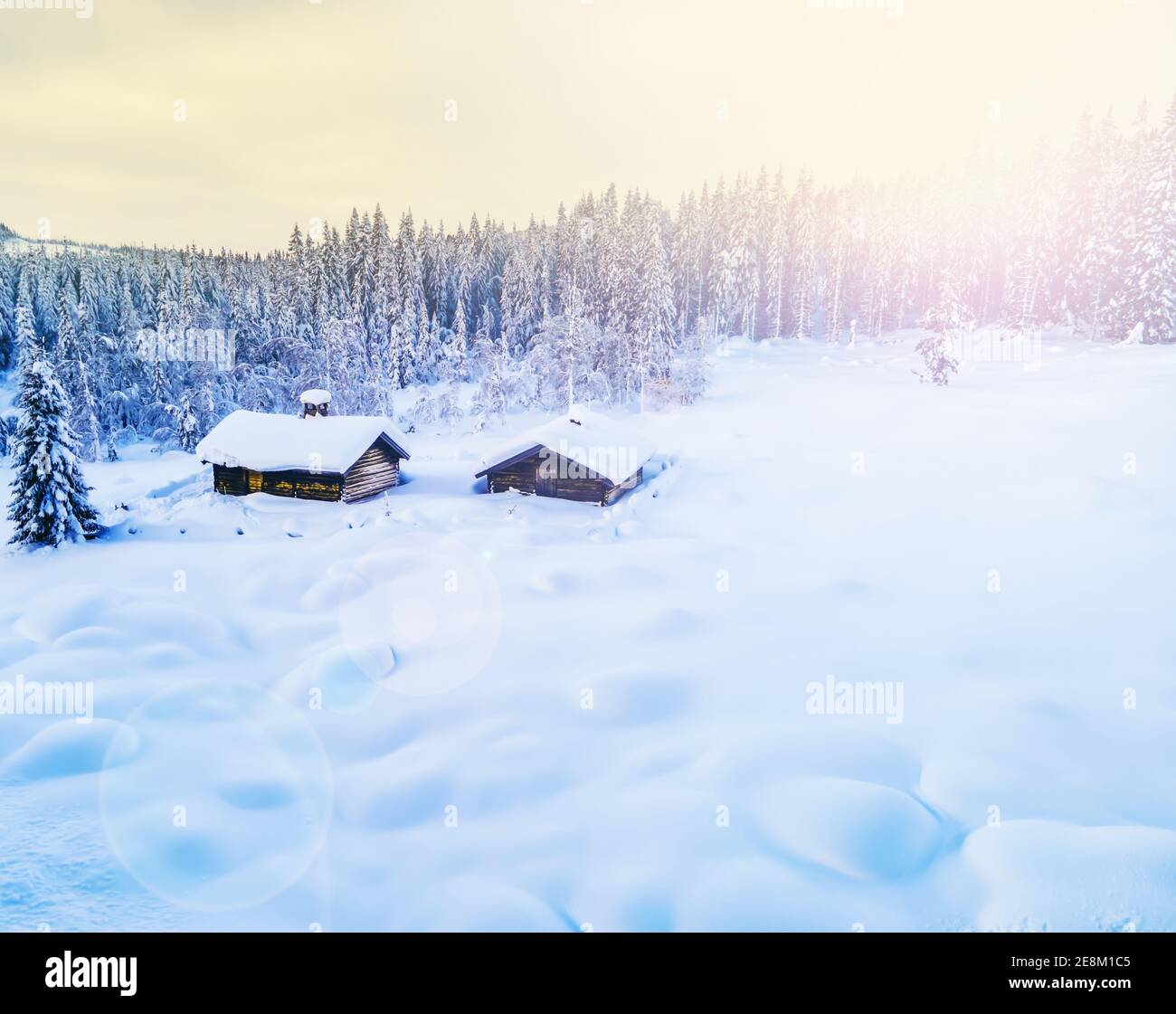 Idyllic mountain log cabin covered in deep snow in a scenic winter ...