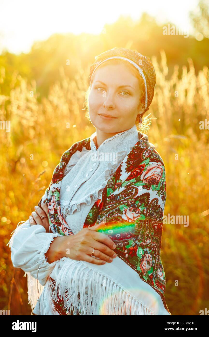 Young beautiful slovak woman in traditional costume on summer daisy ...