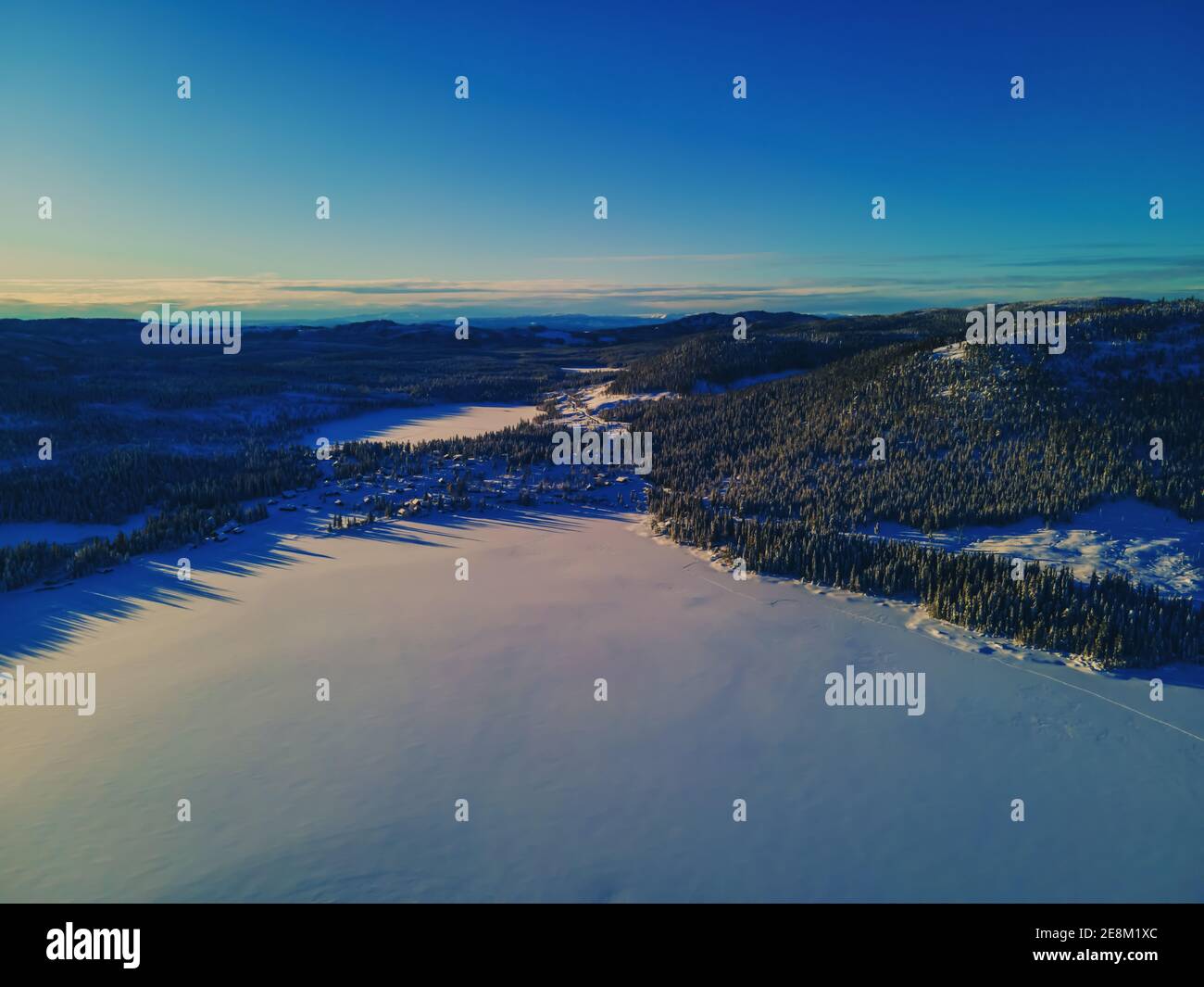 Frozen lake in the Norwegian wilderness, covered in undisturbed snow ...