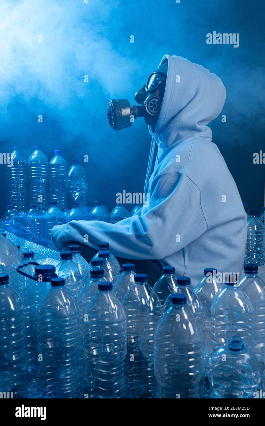 man wearing gas mask to protect himself from plastic pollution. Concept ...