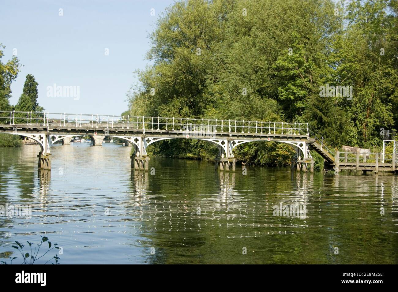 Elegant cast iron footbridge over the River Thames at Guards' Club Park ...
