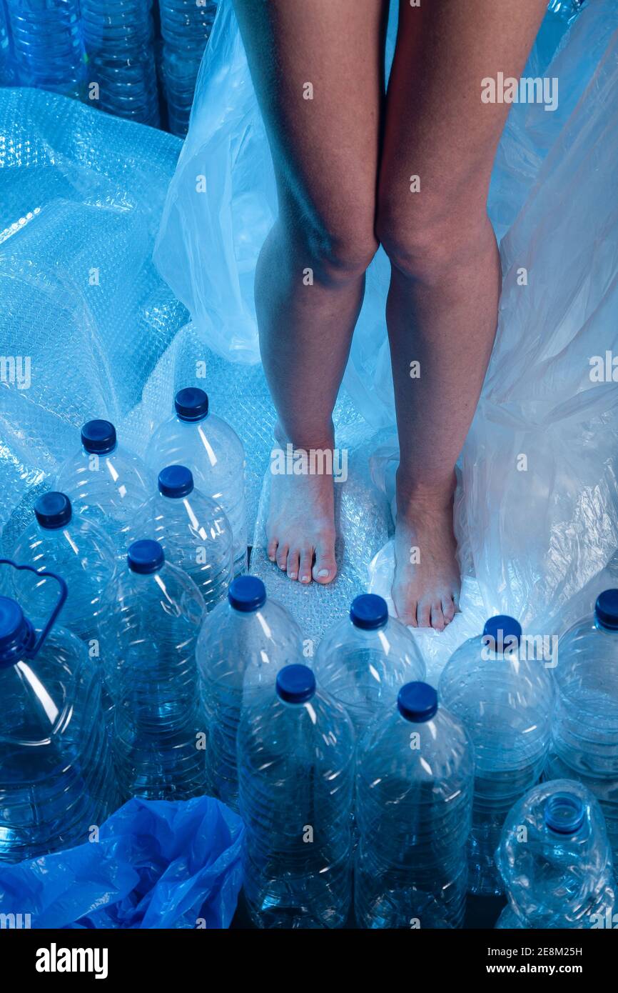 Legs trapped between lot of plastic bottles. Concept of Recycling ...