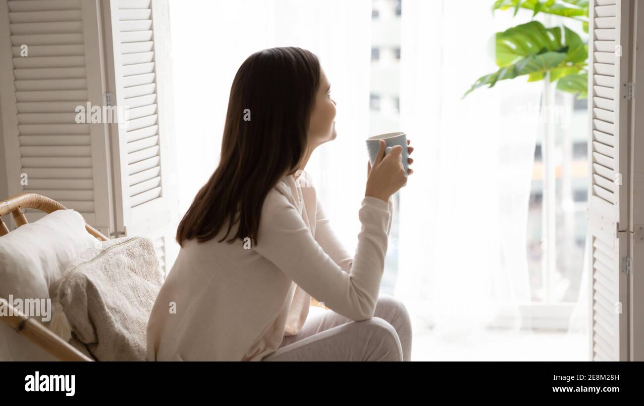 Happy woman relax in home chair drinking tea Stock Photo - Alamy