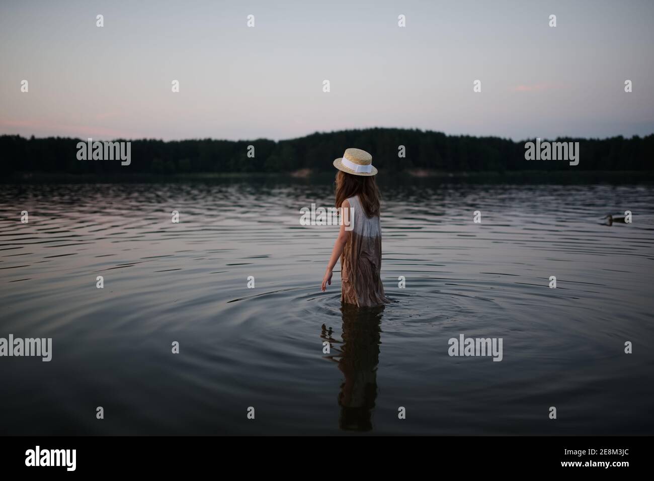 little cute girl with long hair on the lake Stock Photo - Alamy