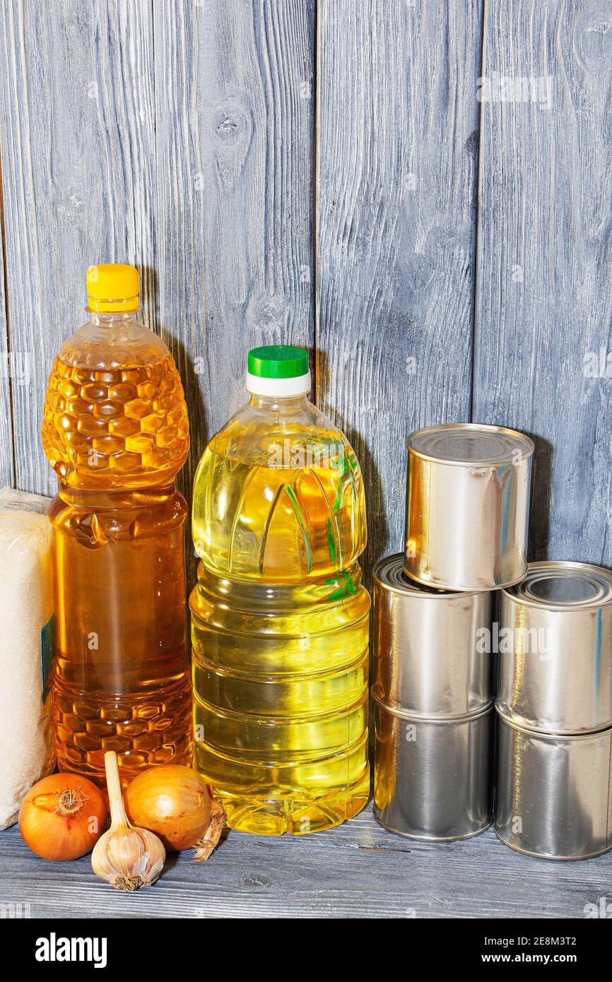 canned food and vegetable oil on a wooden shelf, food crisis Stock ...