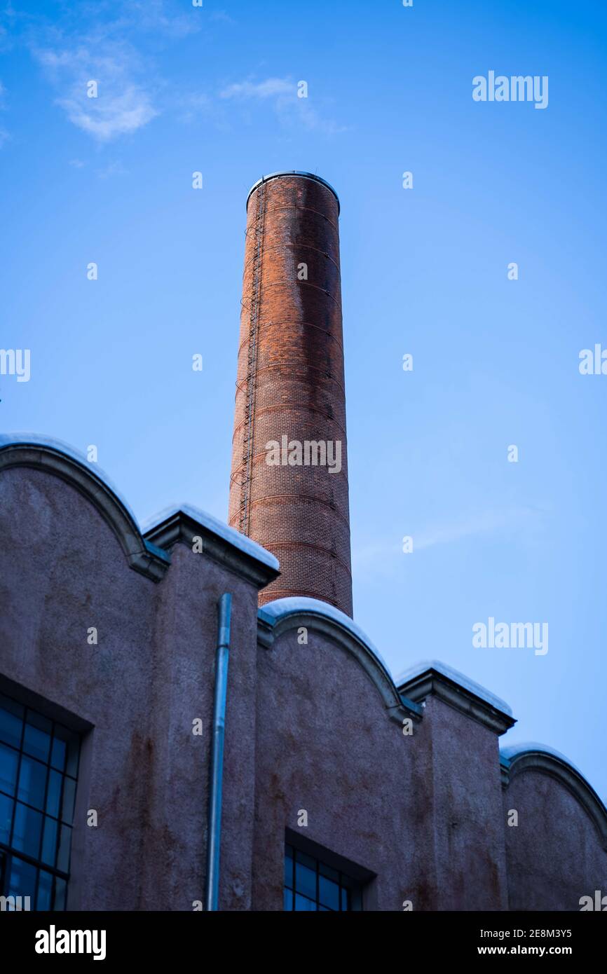 A vertical low angle shot of an old chimney in a factory Stock Photo ...