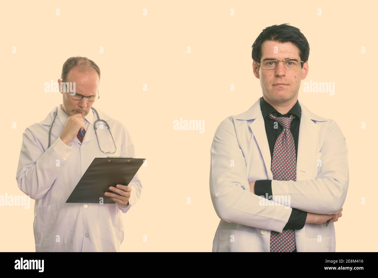 Portrait of two man doctors against studio background Stock Photo - Alamy