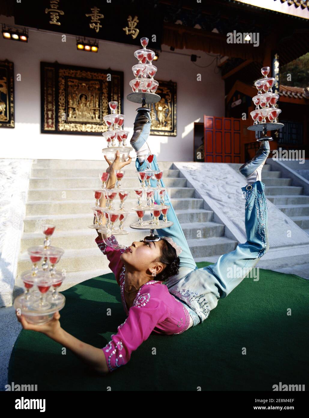 Asia, China, Shanghai, young girl performing balancing act in acrobatic ...