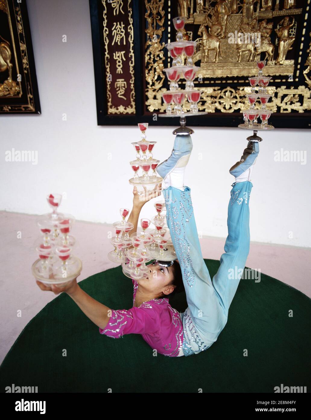 Asia, China, Shanghai, young girl performing balancing act in acrobatic ...