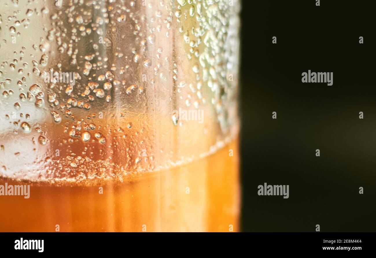 A closeup of the waterdrops on the surface of the glass filled with ...