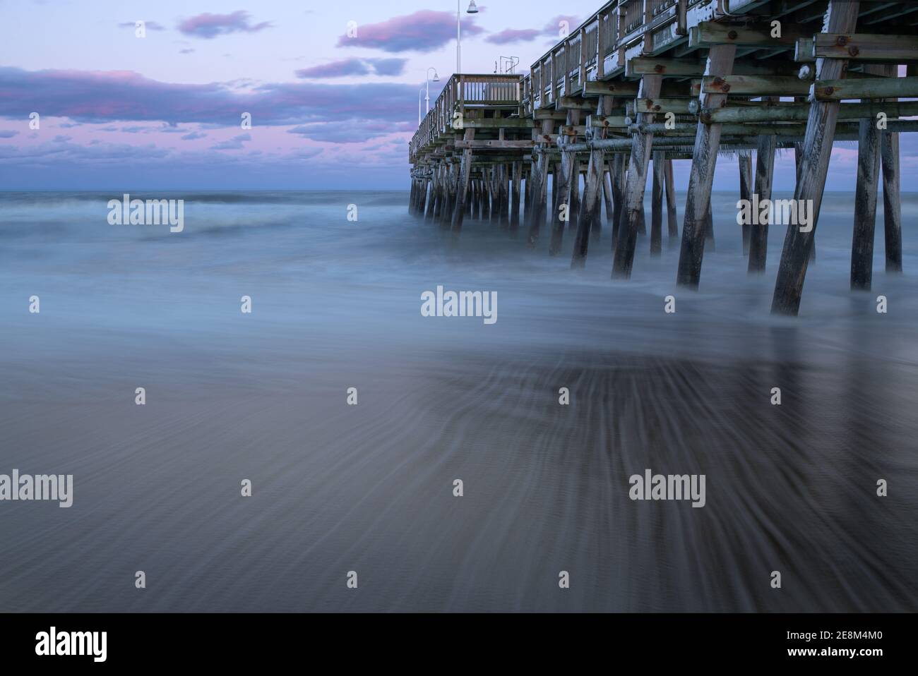 The Sandbridge Fishing Pier in Virginia Beach at sunset, with long ...