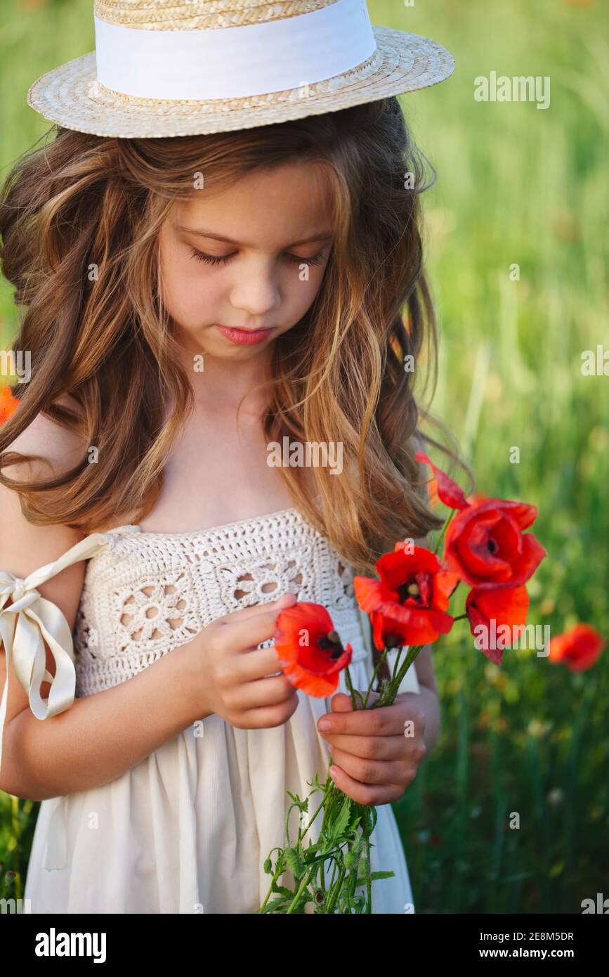 cute little girl in meadow with red poppies Stock Photo - Alamy