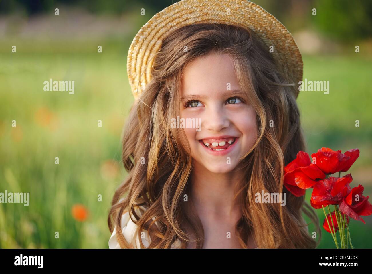cute little girl in meadow with red poppies Stock Photo - Alamy