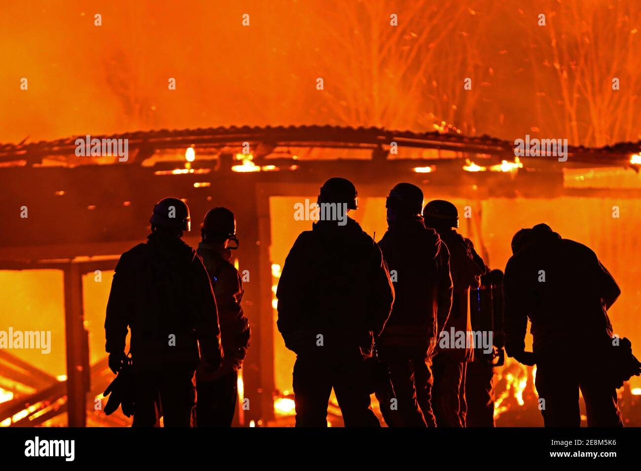 Firemen at a fire scene Stock Photo - Alamy
