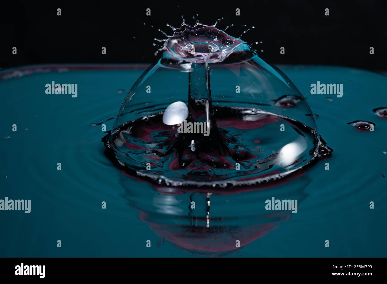 High resolution macro photograph of a colorful water drop splashing ...