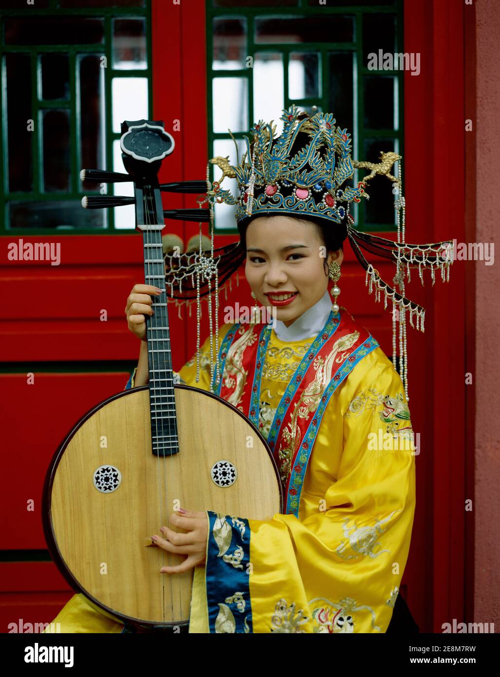 China, Beijing, Woman Dressed in Traditional Costume Playing Musical ...