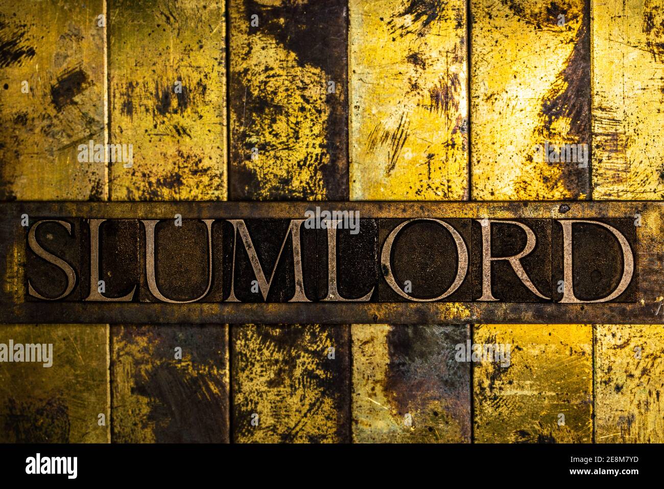 Slumlord text on vintage textured grunge copper and gold background ...