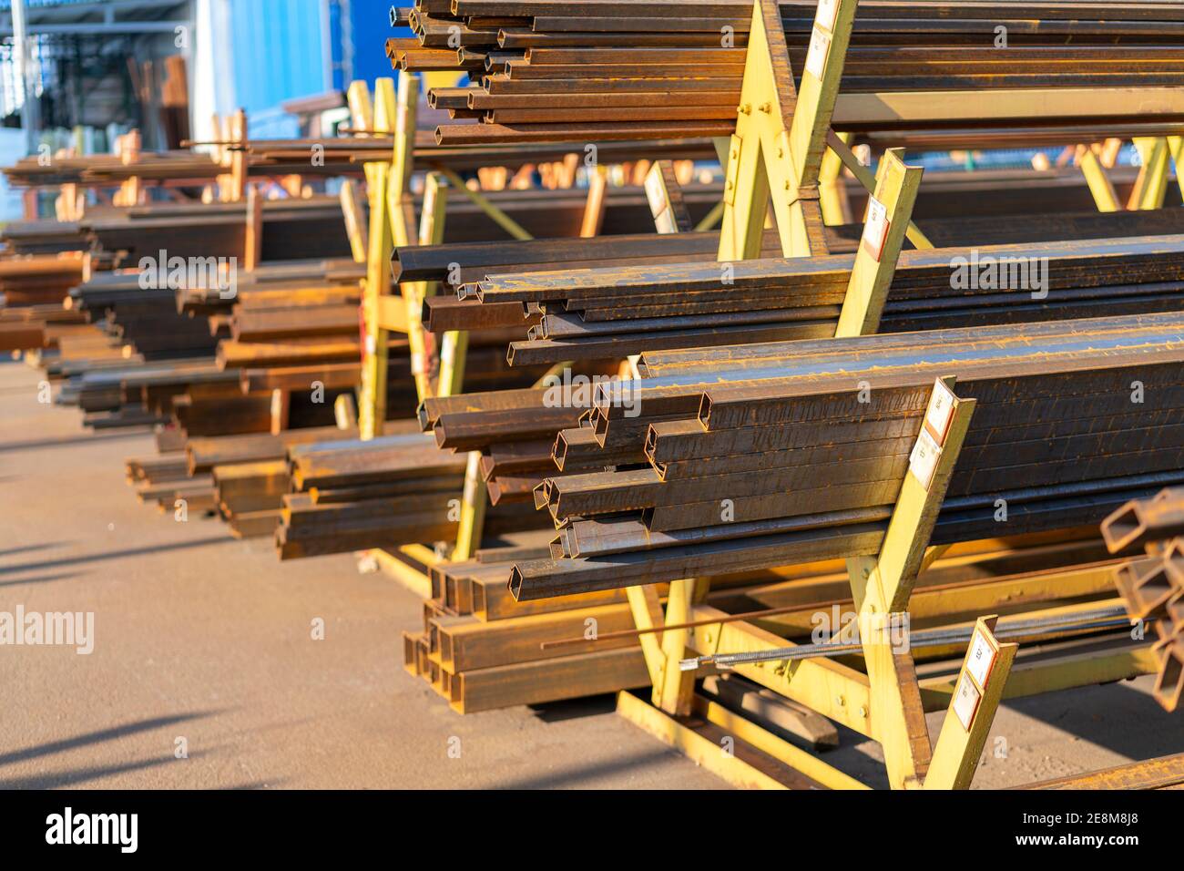 stack of steel pipe and metal beams on rack. metal pipes, profiles ...