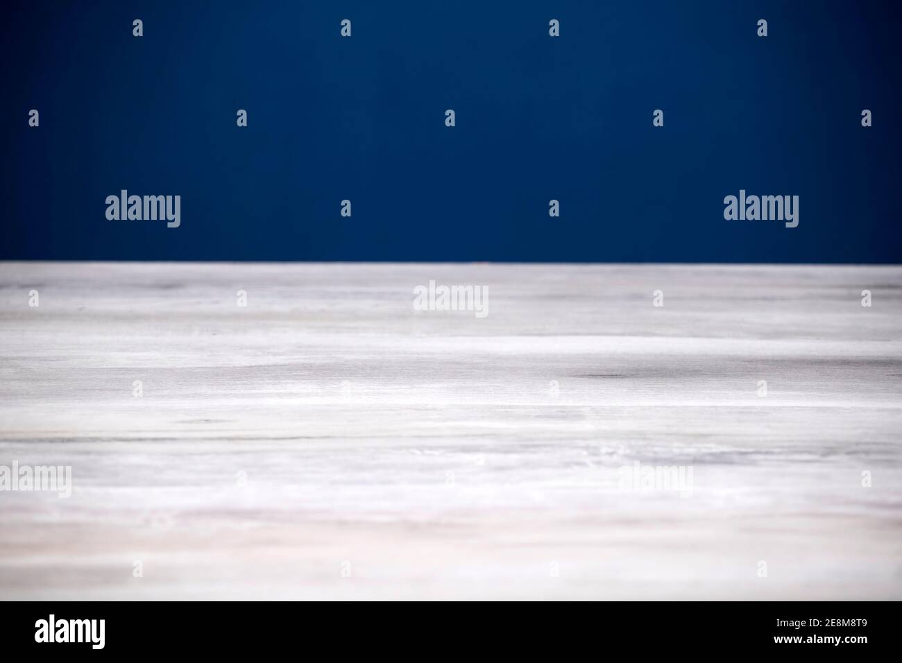 Empty wood table top on blue background Stock Photo - Alamy