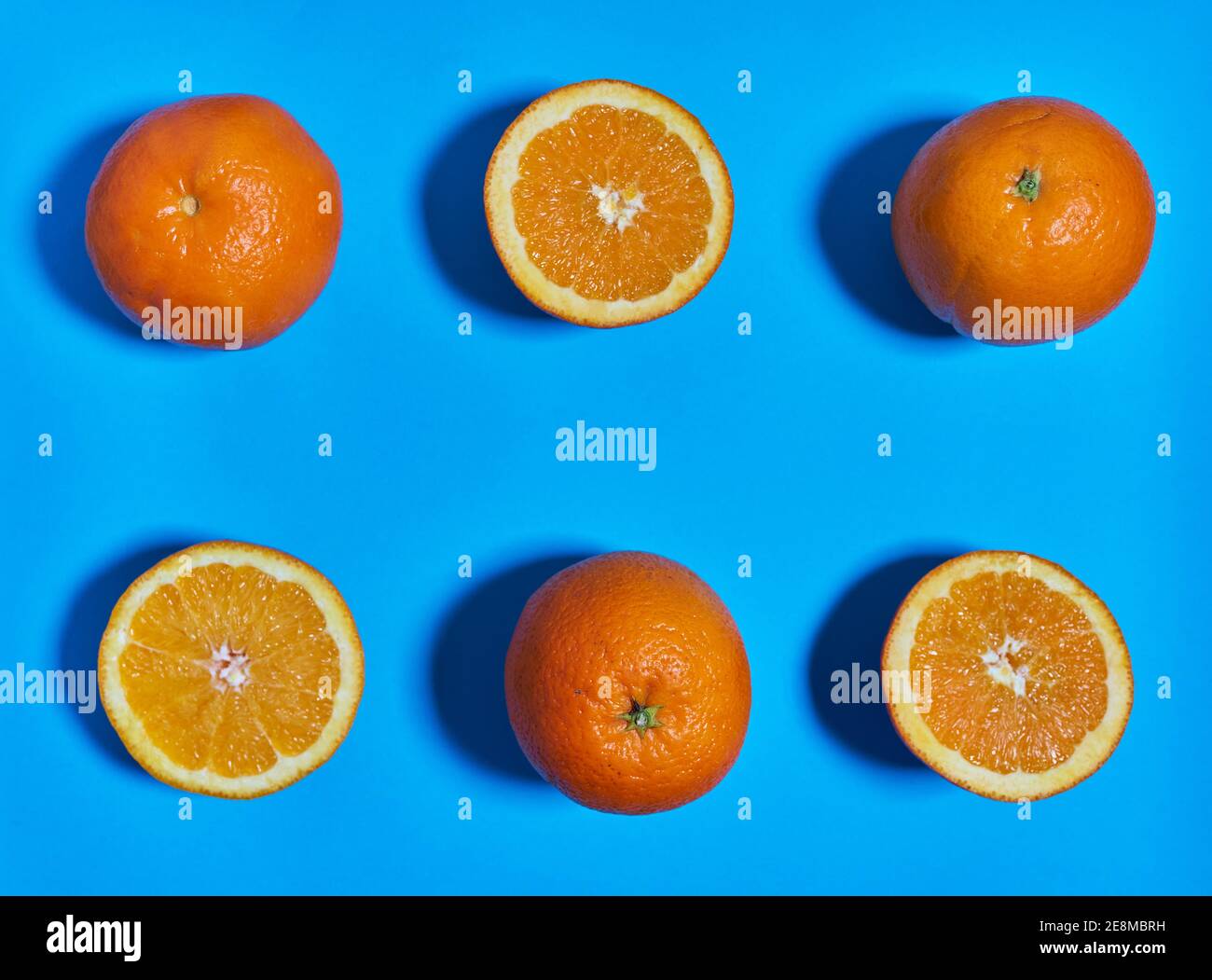 Whole and split oranges on a blue background. CITRUS CITRIC Stock Photo ...