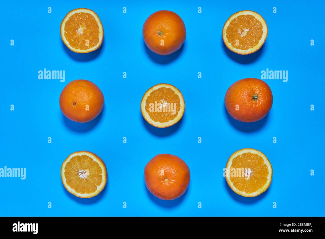 Whole and split oranges on a blue background. CITRUS CITRIC Stock Photo ...