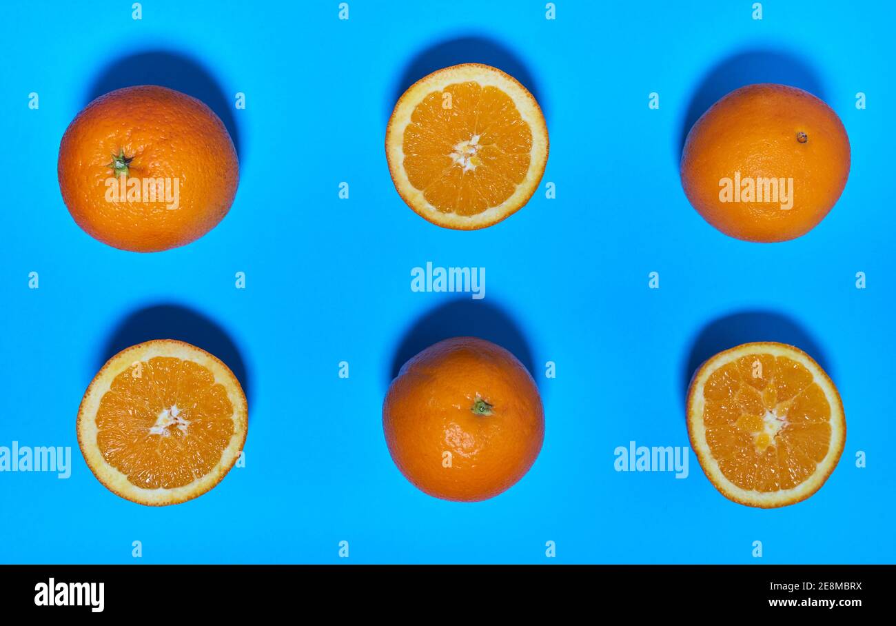 Whole and split oranges on a blue background. CITRUS CITRIC Stock Photo ...