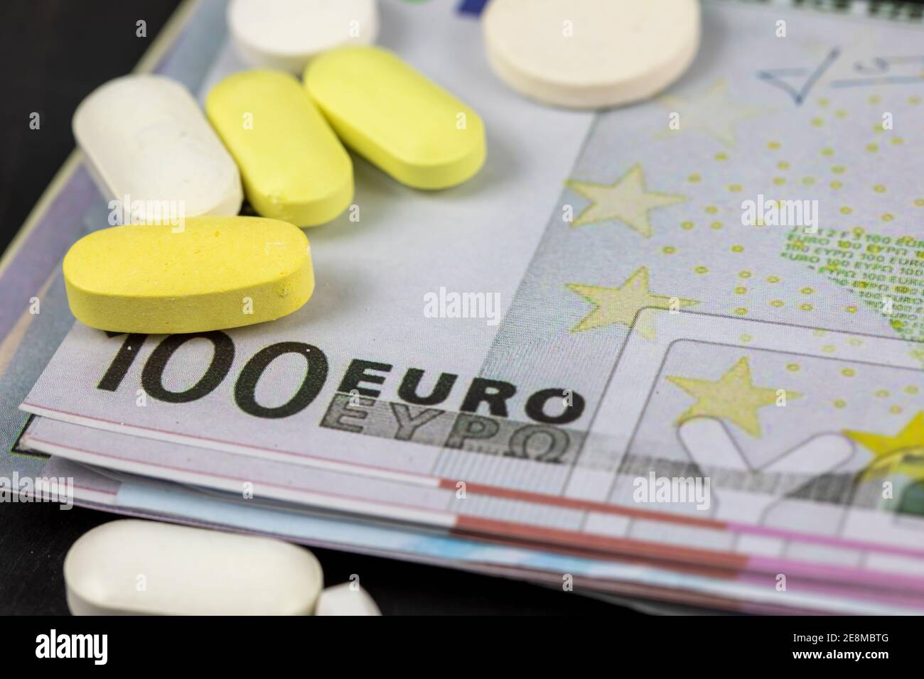 Money and pill, pharmacy concept Stock Photo - Alamy