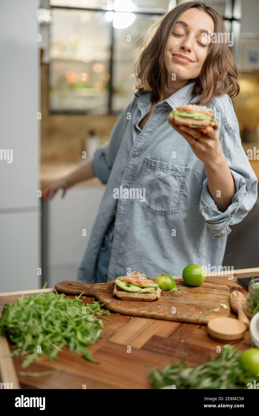 Happy slim woman showing her weight loss Stock Photo - Alamy