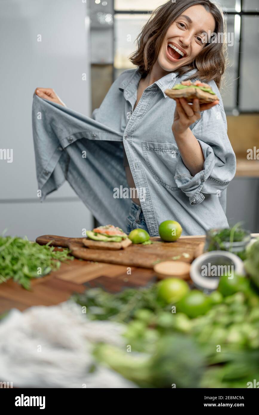Happy slim woman showing her weight loss Stock Photo - Alamy