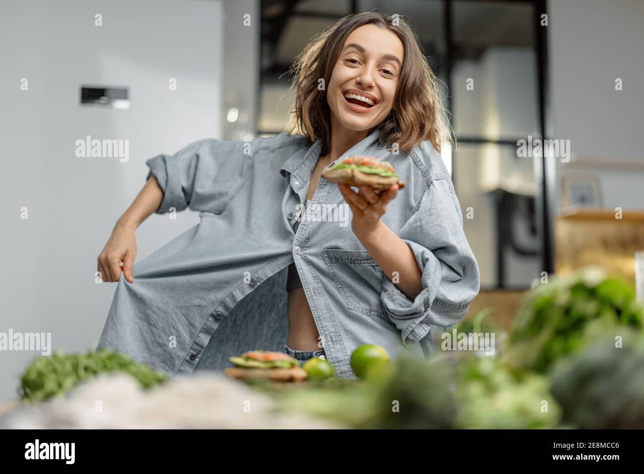 Happy slim woman dancing and showing her weight loss Stock Photo - Alamy