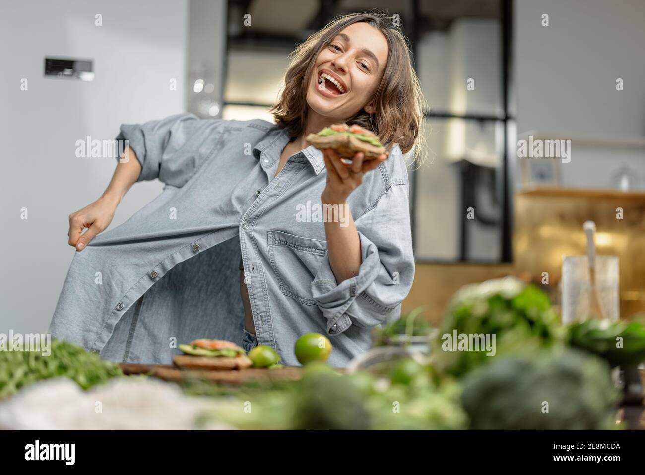 Happy slim woman showing her weight loss Stock Photo - Alamy