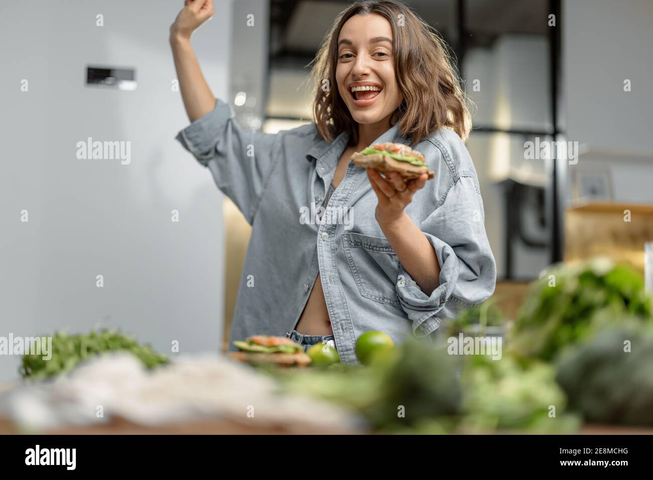 Happy slim woman dancing and showing her weight loss Stock Photo - Alamy