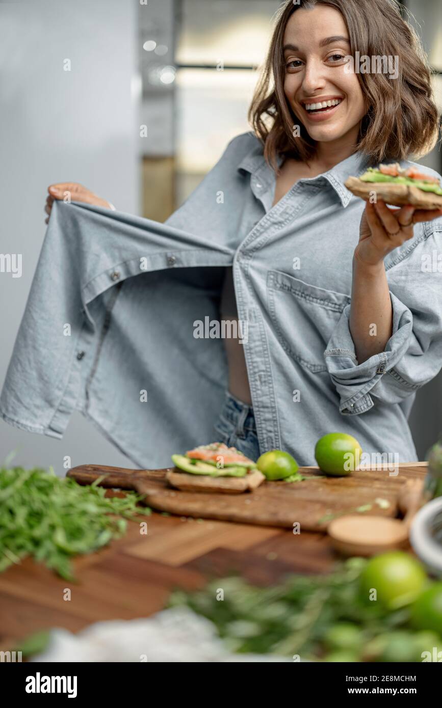 Happy slim woman showing her weight loss Stock Photo - Alamy