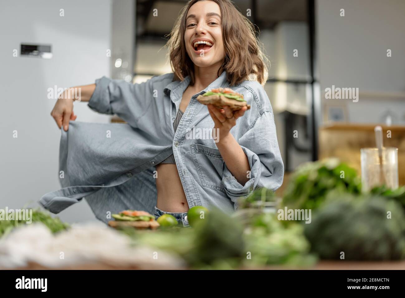 Happy slim woman dancing and showing her weight loss Stock Photo - Alamy
