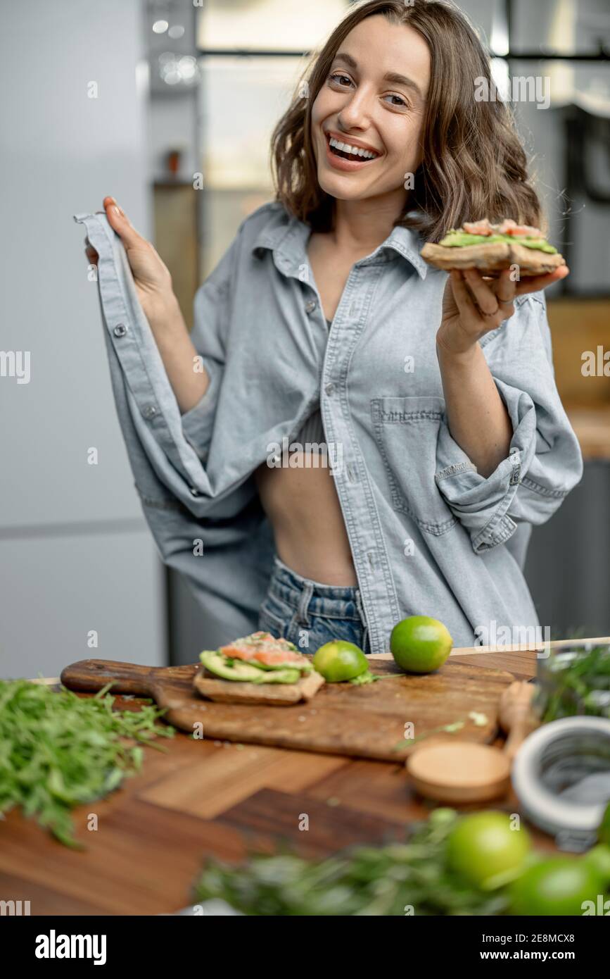 Happy slim woman showing her weight loss Stock Photo - Alamy
