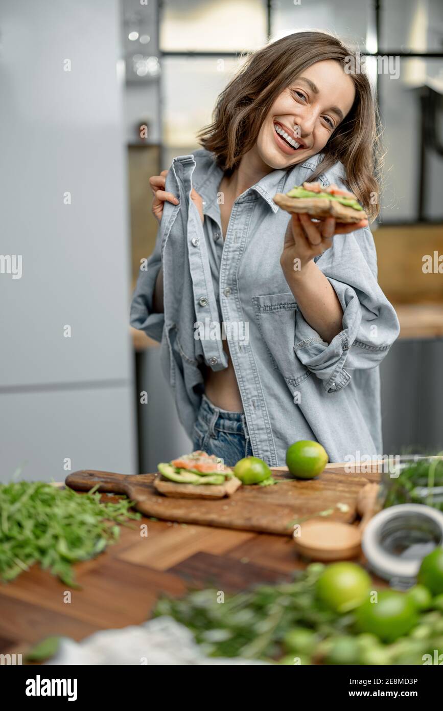 Happy slim woman showing her weight loss Stock Photo - Alamy