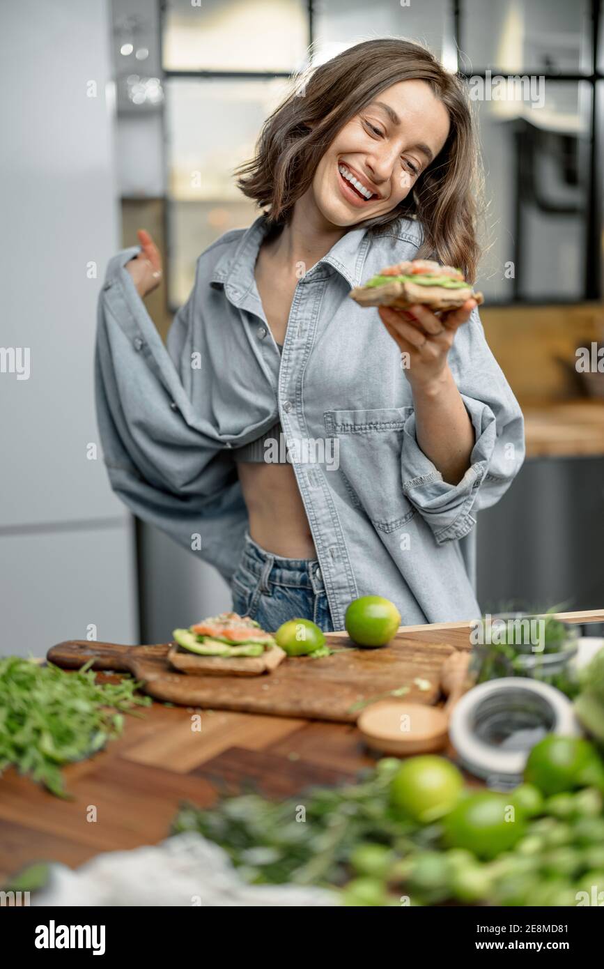 Happy slim woman showing her weight loss Stock Photo - Alamy