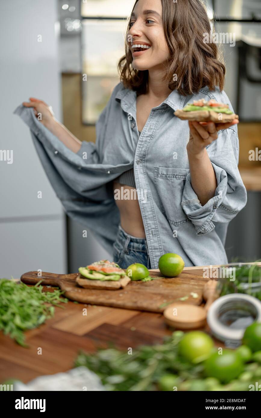 Happy slim woman showing her weight loss Stock Photo - Alamy