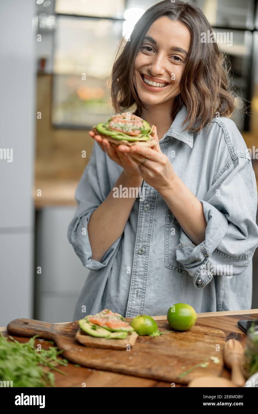 Happy slim woman with healthy green food Stock Photo - Alamy