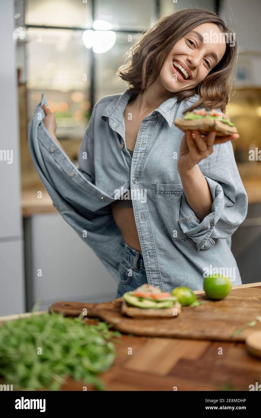 Happy slim woman showing her weight loss Stock Photo - Alamy