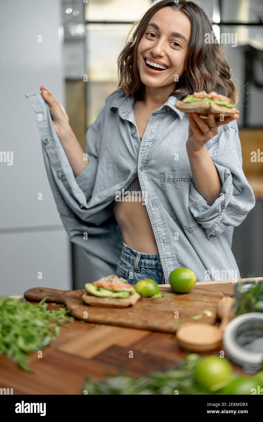 Happy slim woman showing her weight loss Stock Photo - Alamy