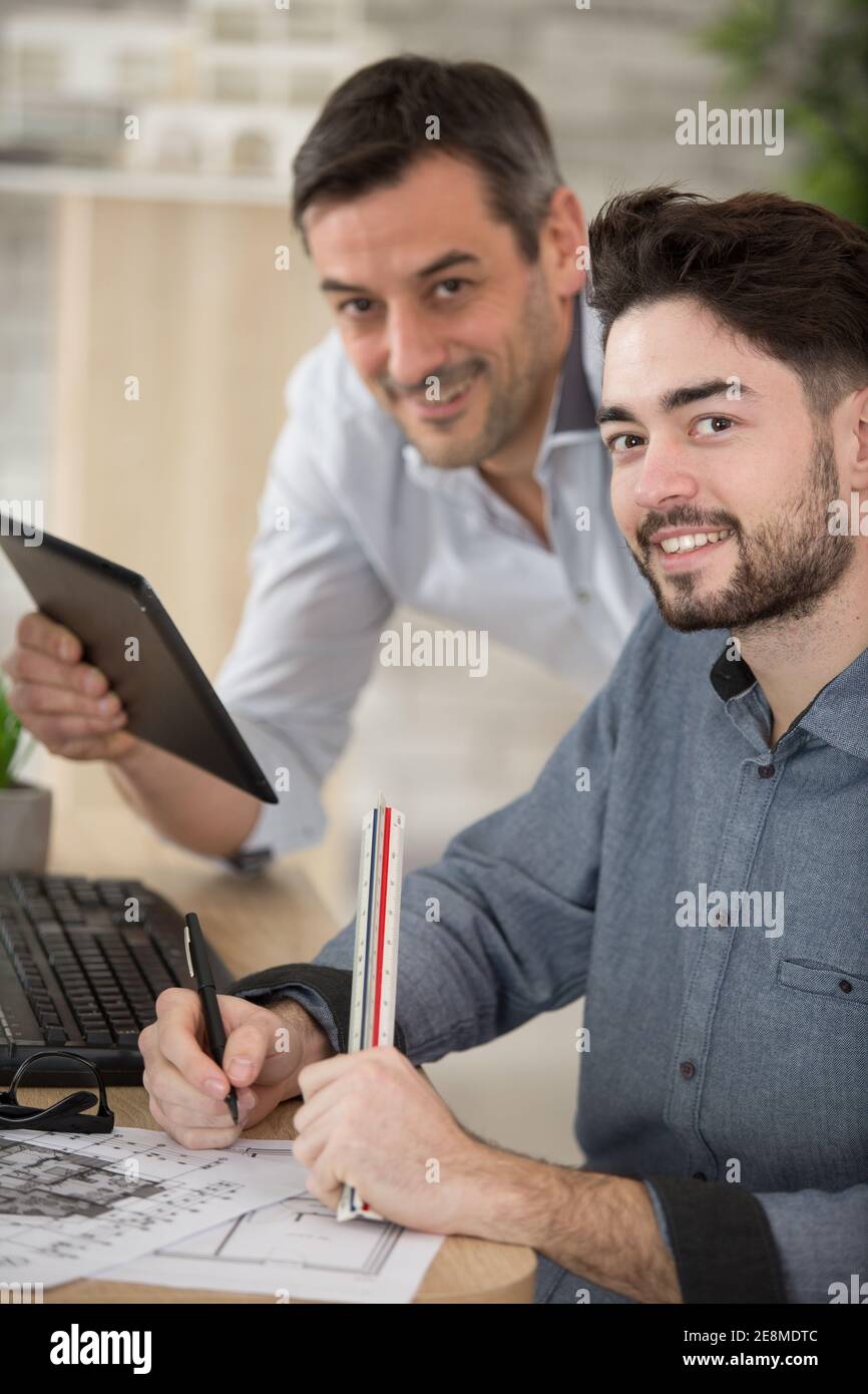 two male architects at desk using computer and tablet Stock Photo - Alamy