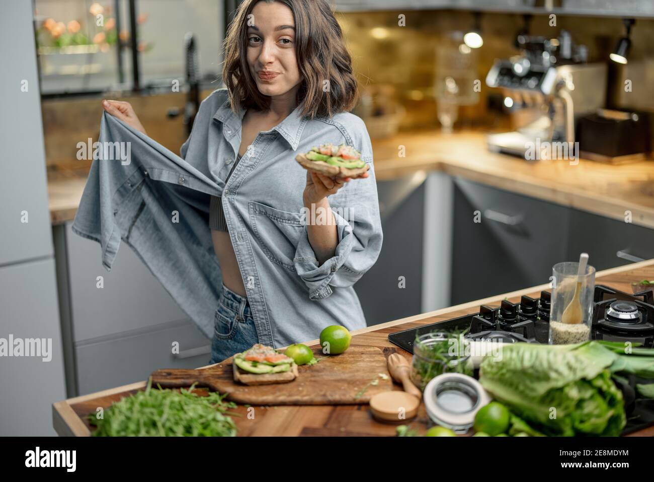 Happy slim woman showing her weight loss Stock Photo - Alamy