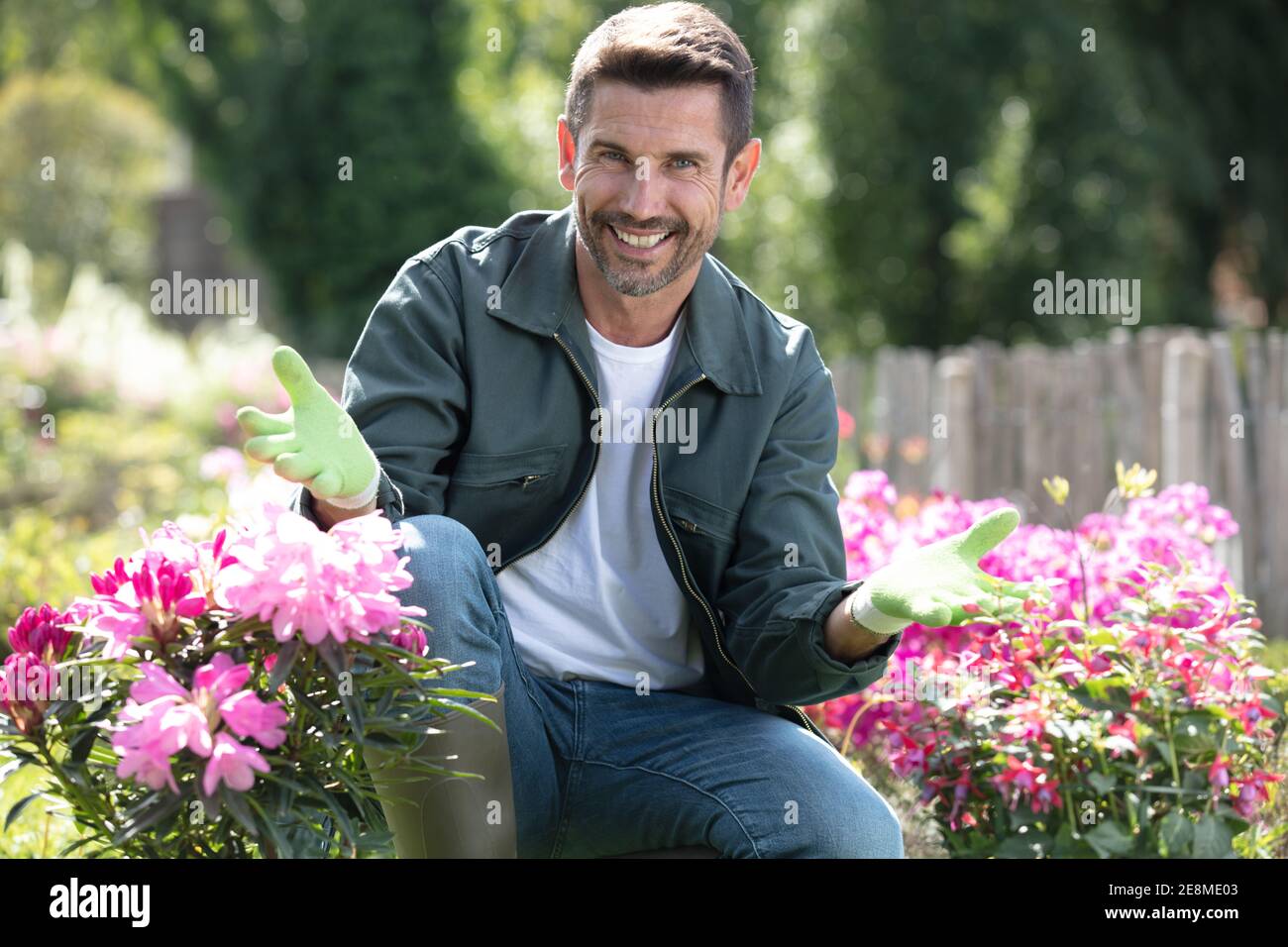 happy young man gardening in backyard Stock Photo - Alamy