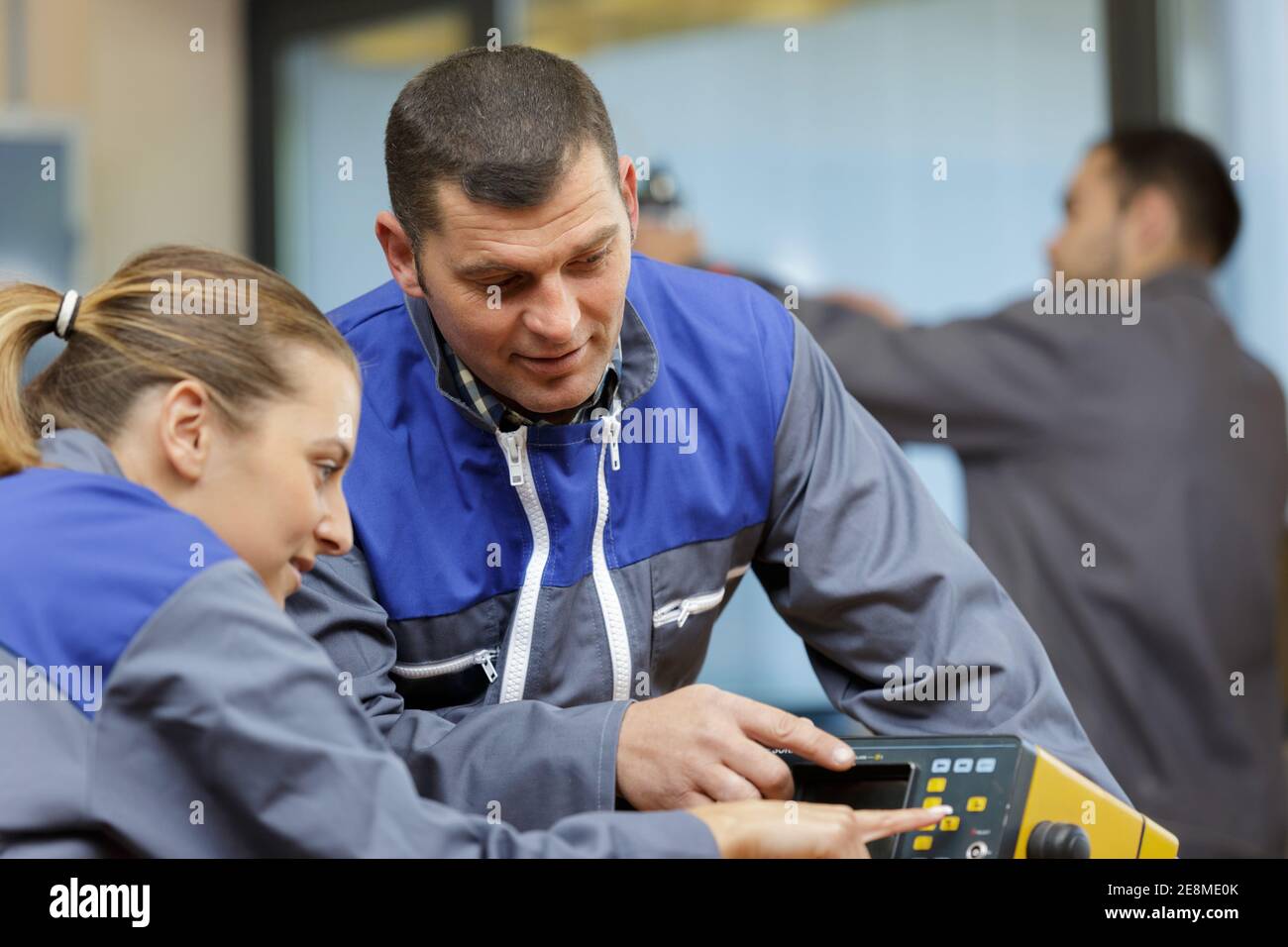 female apprentice learning which buttons to press Stock Photo - Alamy
