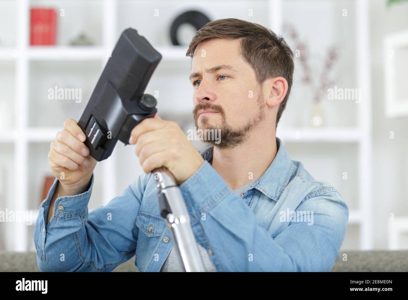 Man hoovering room hi-res stock photography and images - Alamy