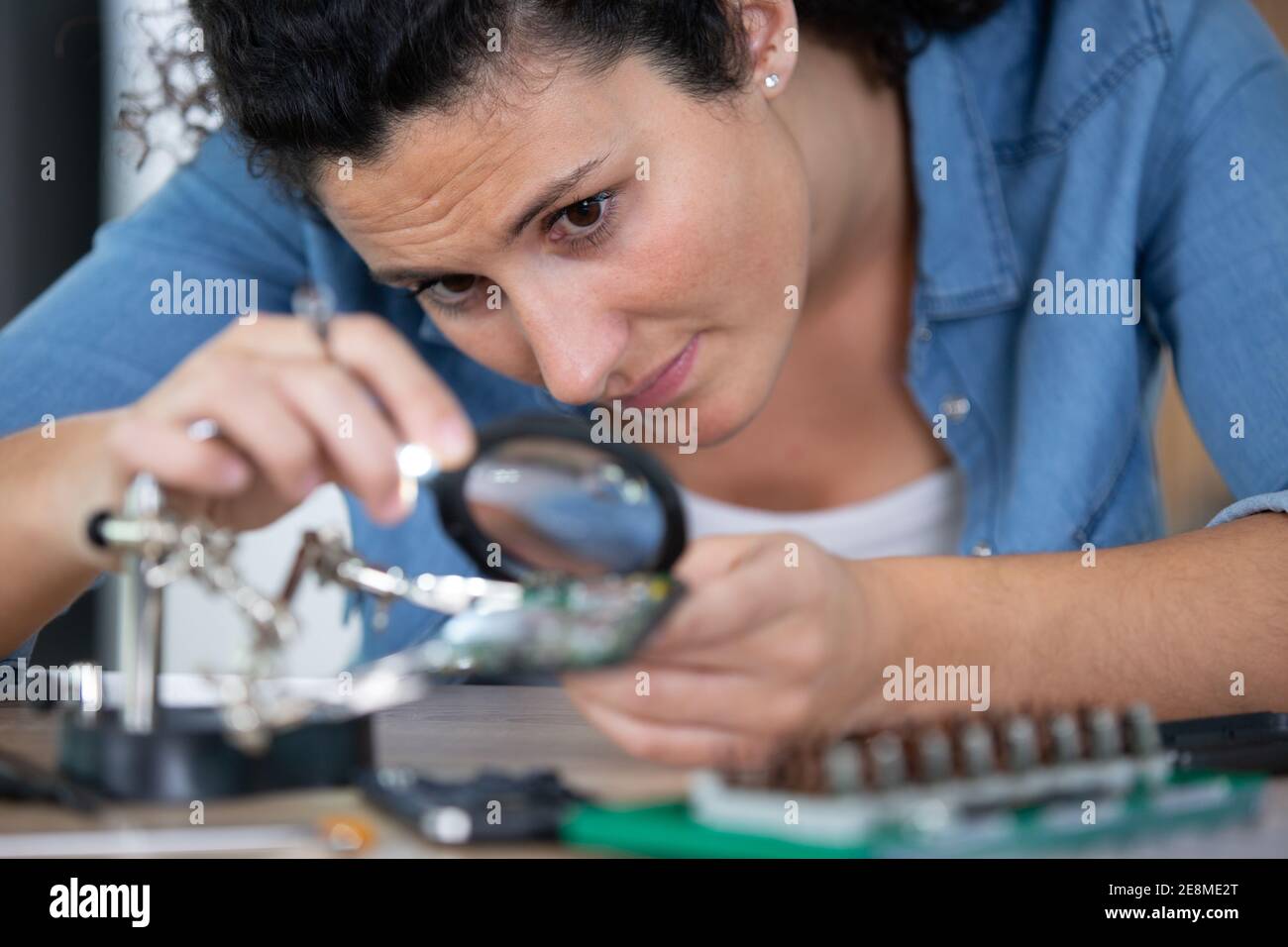 women technician fixing mobile phone repair and maintenance services ...